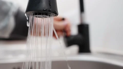 Turning on water in modern kitchen tap h... | Stock Video | Pond5