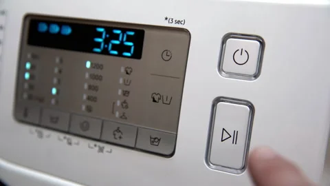 Turns the washing machine on and off wit... | Stock Video | Pond5