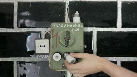 Twisting the ceramic fuses on old switch... | Stock Video | Pond5