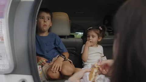 Two adorable kids, sitting in the trunk ... | Stock Video | Pond5