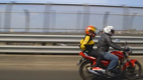 Two adult men ride on motorcycle. | Stock Video | Pond5