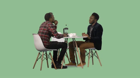 Two African men sitting at a table in a ... | Stock Video | Pond5