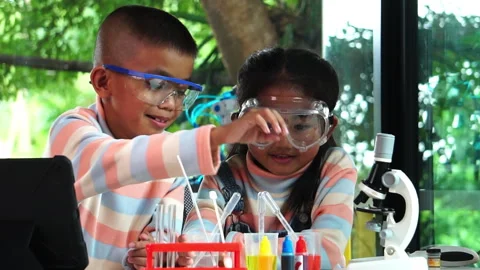 Two asia kids testing chemistry lab expe... | Stock Video | Pond5