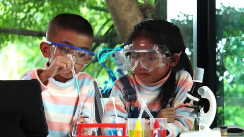 Two asia kids testing chemistry lab expe... | Stock Video | Pond5