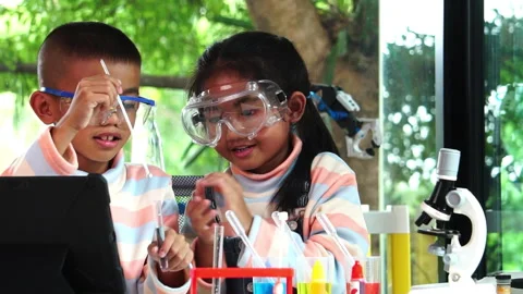 Two asia kids testing chemistry lab expe... | Stock Video | Pond5
