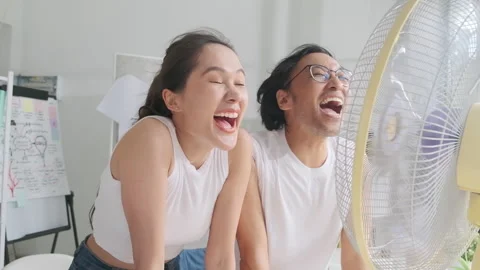 Two Asian workers are blowing wind with ... | Stock Video | Pond5