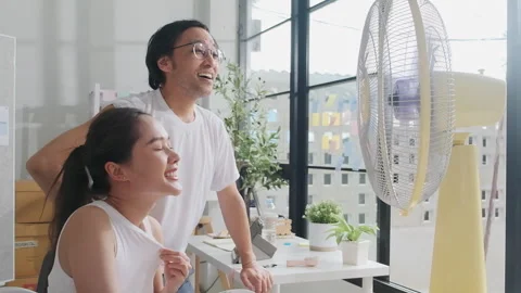 Two Asian workers are blowing wind with ... | Stock Video | Pond5