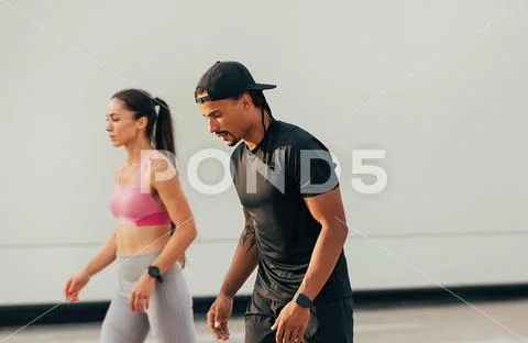 Two athletes preparing to run outdoors. Man and woman relaxing before ...