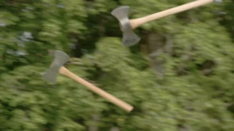 two axes flying and thrown on the logboa... | Stock Video | Pond5