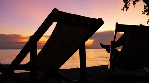 Two beach chairs stand on beach to watch... | Stock Video | Pond5