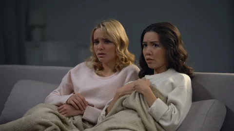 Two beautiful scared girls watching horr... | Stock Video | Pond5