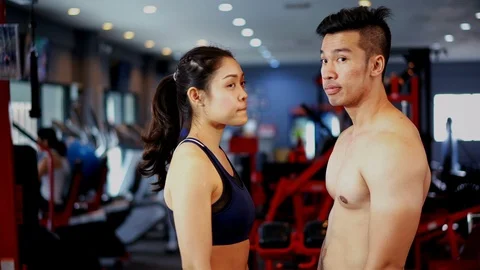 Two bodybuilder are smiling at fitness g... | Stock Video | Pond5