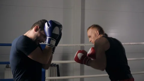 Two boxer men fighting on boxing ring in... | Stock Video | Pond5
