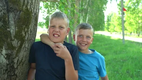 Two boys, 10 and 12 years old, hug and p... | Stock Video | Pond5