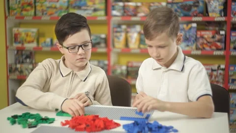 Two boys erect buildings from a children... | Stock Video | Pond5