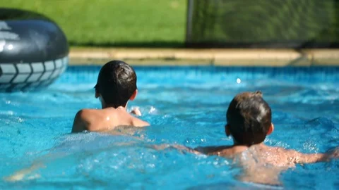 Two boys having fun at the backyard swim... | Stock Video | Pond5
