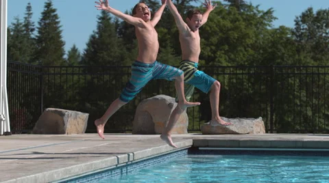 Two boys jumping into pool in super slow... | Stock Video | Pond5