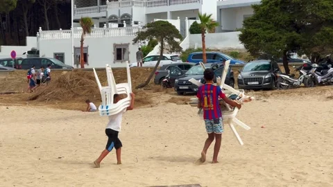 Two boys moving plastic chairs and table... | Stock Video | Pond5