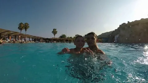 Two boys push water on a cameraman on a ... | Stock Video | Pond5