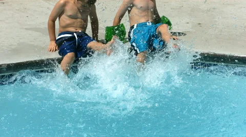 Two boys splashing feet in pool, slow mo... | Stock Video | Pond5
