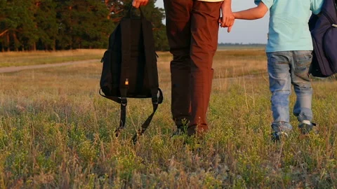 Two boys walk with backpacks at sunset. ... | Stock Video | Pond5