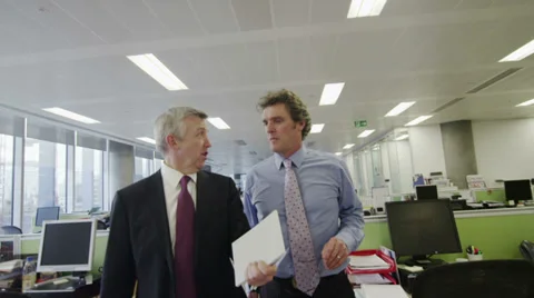Two businessmen chat together as they wa... | Stock Video | Pond5