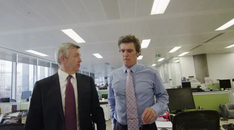 Two businessmen chat together as they wa... | Stock Video | Pond5