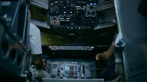 Two caucasian male pilots in the cockpit... | Stock Video | Pond5