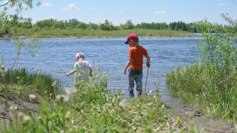 Two children catch fish on the river Ban... | Stock Video | Pond5