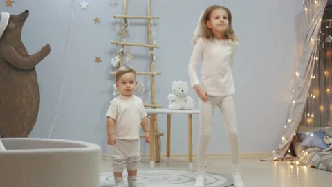 Two children dancing, jumping at home. S... | Stock Video | Pond5