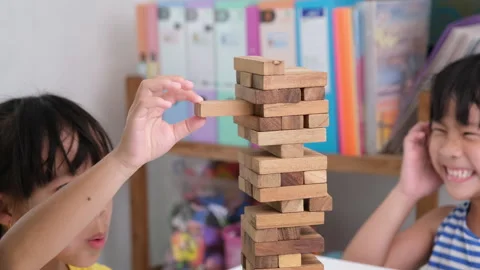 Two children playing Jenga board game o... | Stock Video | Pond5
