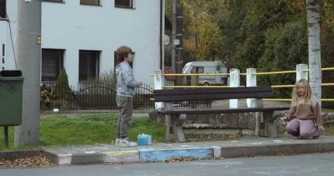 Two children wave at cyclists passing th... | Stock Video | Pond5