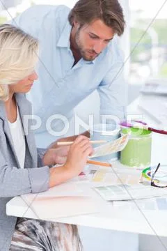 Two colleagues of interior design working together on colour charts ...