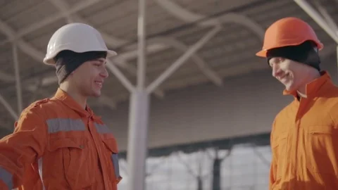 Two construction workers high five. They... | Stock Video | Pond5