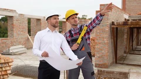 Two construction workers look at an arch... | Stock Video | Pond5