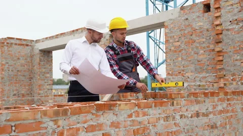 Two construction workers look at an arch... | Stock Video | Pond5