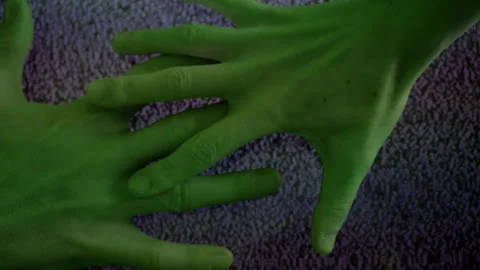 Two Crawling Green Hands Slide by the Sc... | Stock Video | Pond5