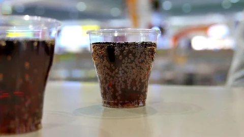 Two cups of coca cola on table inside sh... | Stock Video | Pond5