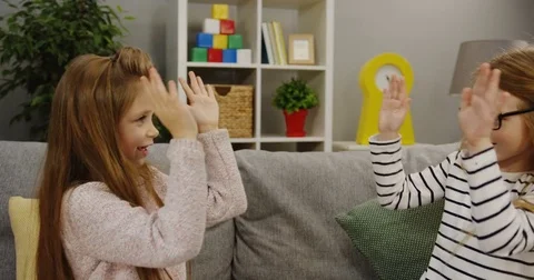 Two cute similar girls playing hands gam... | Stock Video | Pond5