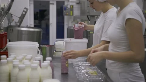 Two dairy factory workers packaging fres... | Stock Video | Pond5