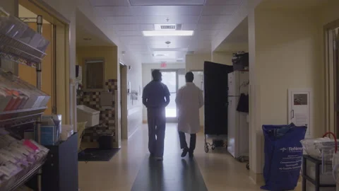 Two Doctors Walking Down A Hospital Hall... | Stock Video | Pond5
