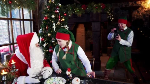 Two elves and Santa photographing on Chr... | Stock Video | Pond5
