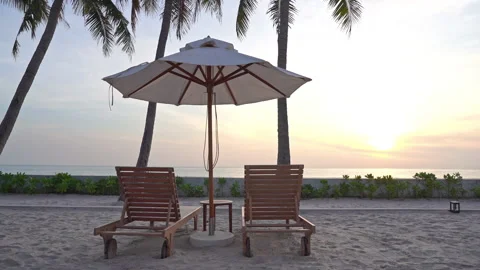 Two empty sun loungers face out on a tro... | Stock Video | Pond5