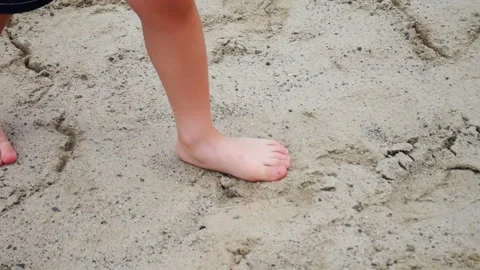 Two feet of a little boy taking steps on... | Stock Video | Pond5