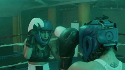 Two female boxers in helmets and boxing ... | Stock Video | Pond5