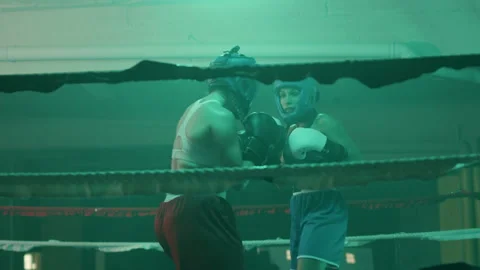 Two female boxers in helmets and boxing ... | Stock Video | Pond5