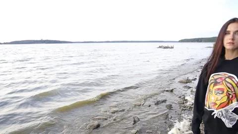 Two female models posing next to a lake | Stock Video | Pond5