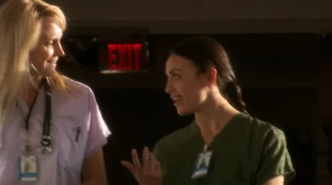 Two female nurses walking and talking in... | Stock Video | Pond5