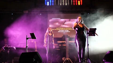 Two female singers on stage singing in p... | Stock Video | Pond5