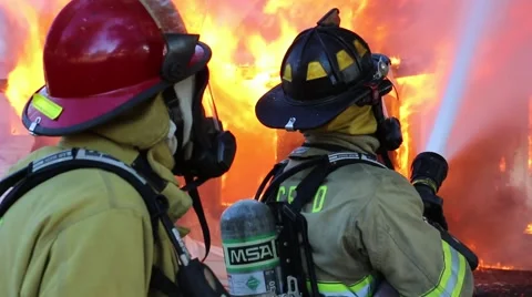 Two Firefighters fighting a fire | Stock Video | Pond5